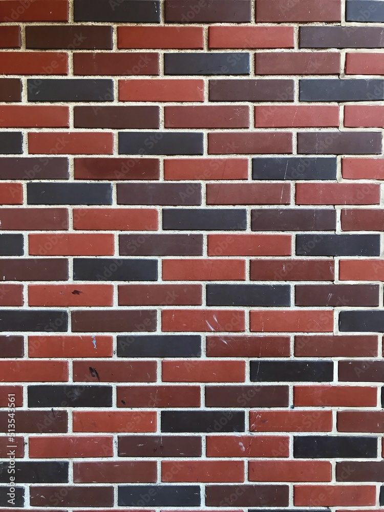 Bright stock photo of a red-orange and blue brick false facade. Close ...