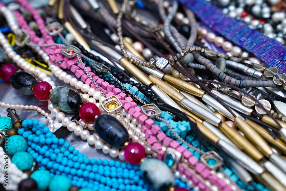 Necklaces made of beads of various colors, shapes, and materials are ...
