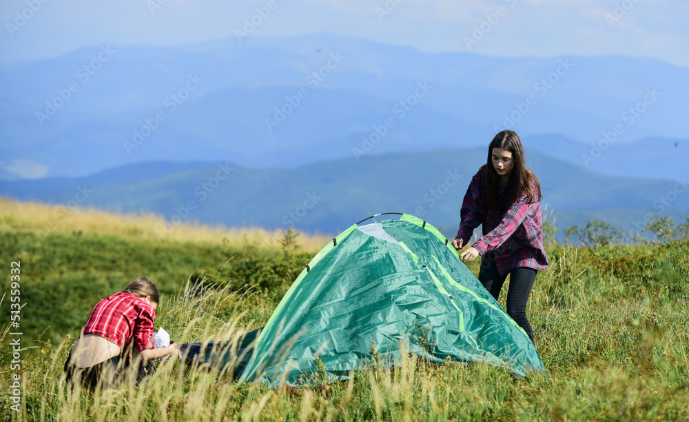 best therapy. mountain tourism camp. two girls pitch tent. wanderlust ...