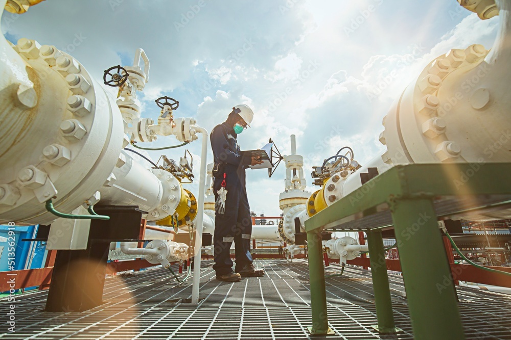 Male worker inspection at steel long pipes and pipe elbow in station ...