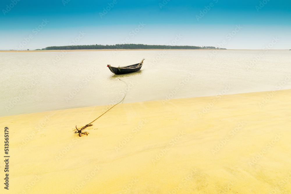 Moody image of a boat on water tied by a rope with an anchor on river ...