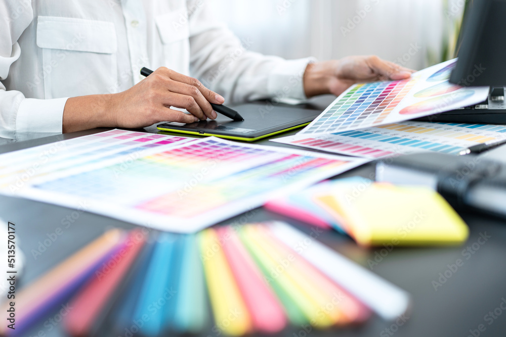 Young creative graphic designer working on color selection and drawing ...