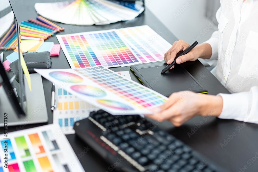 Young creative graphic designer working on color selection and drawing ...