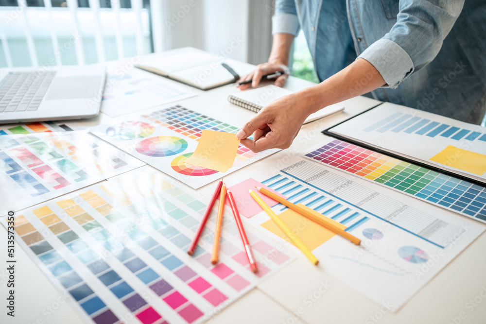 Young creative graphic designer working on color selection and drawing ...
