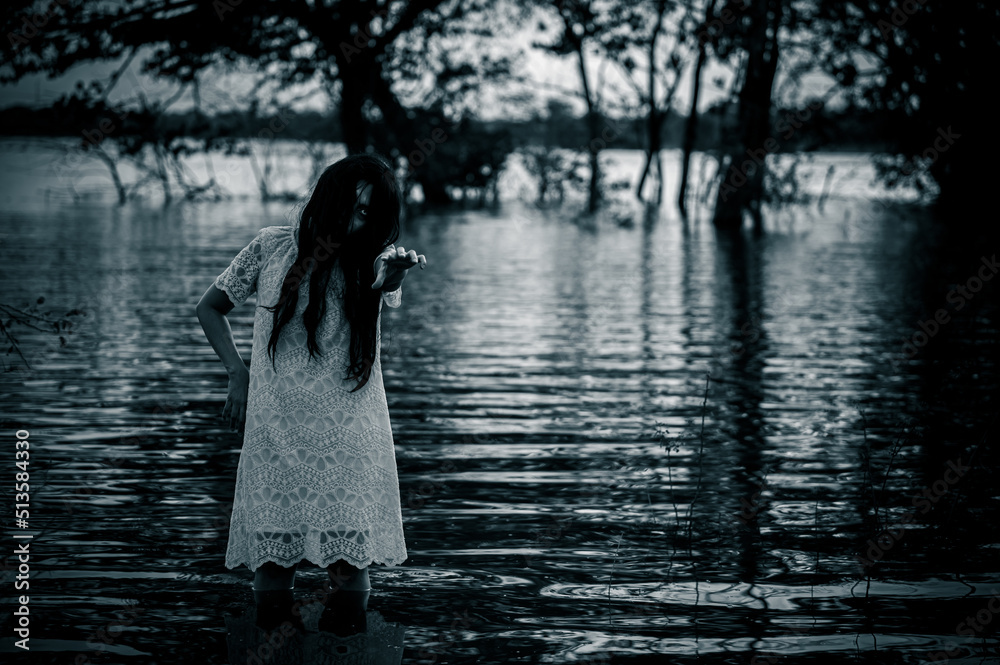 Portrait of asian woman make up ghost face at the swamp,Horror in water ...