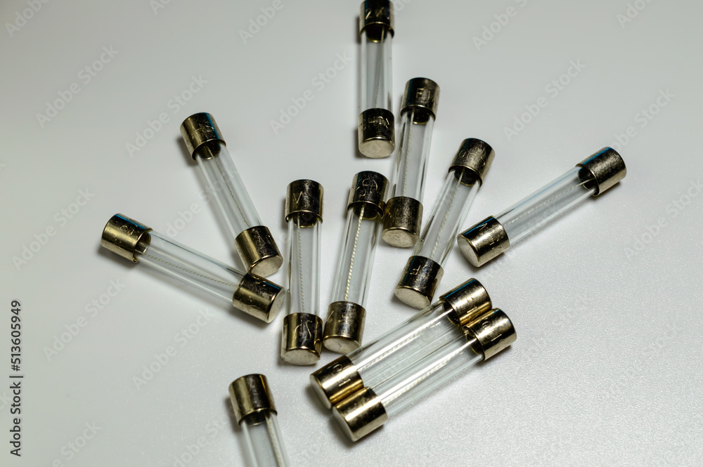 Small pile of clear electrical fuses on a white background. Set of ...