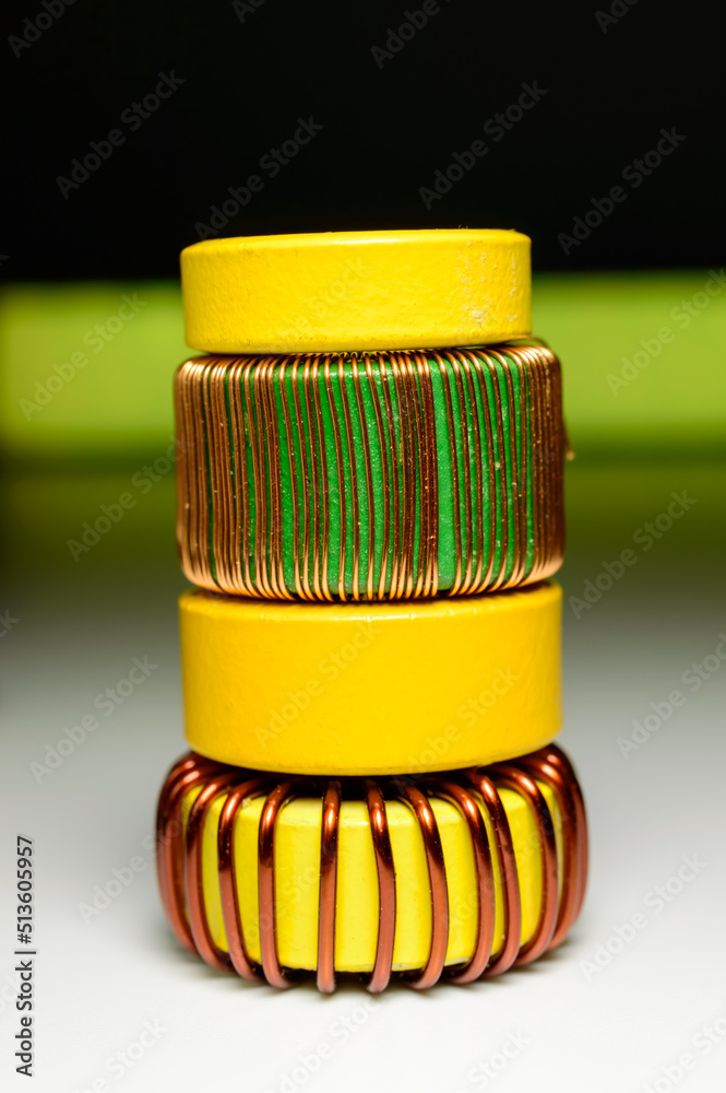 Toroids standing on top of each other on a white background with yellow ...