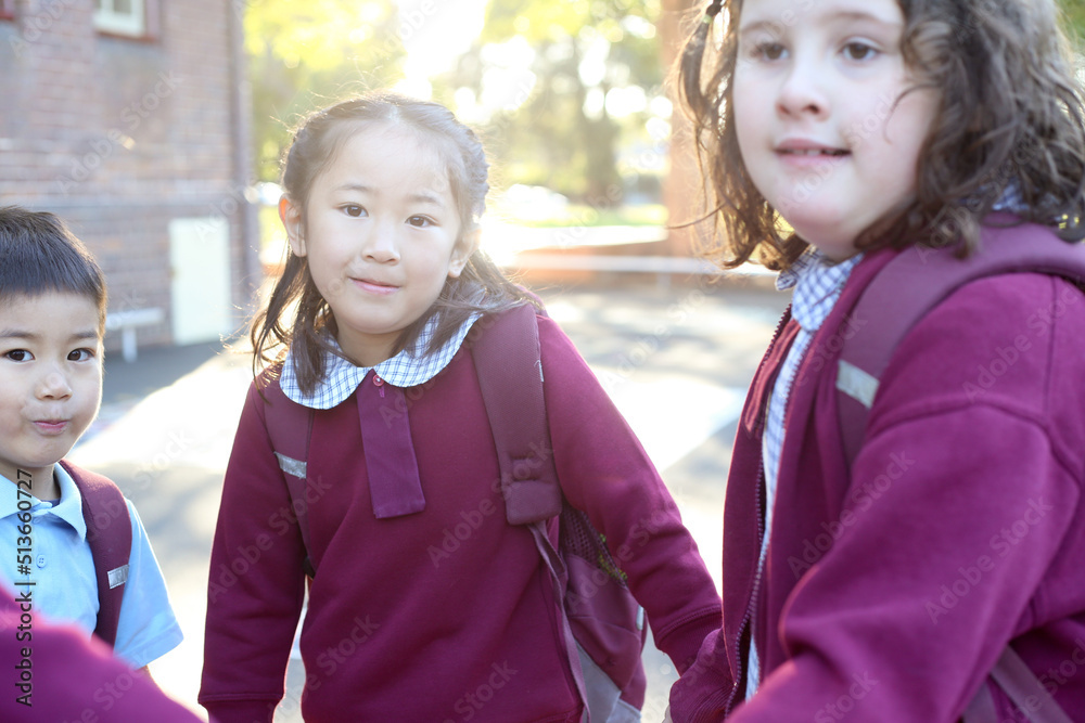 School children holding hands and playing in the school yard foto de ...