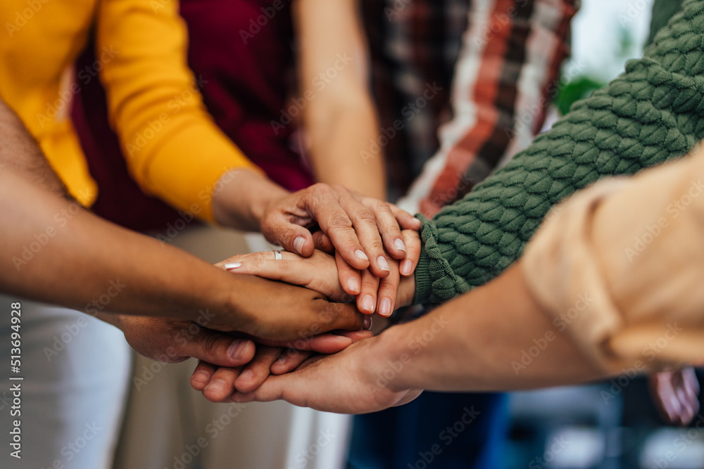 Group of people holding hands together, one over the other, being ...