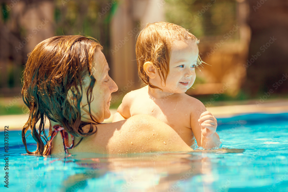 Mom and daughter in the pool. Family happiness. Summer outdoor fun in ...