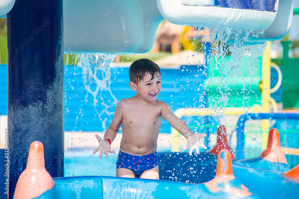 beautiful child playing in the pools of a water park in summer Stock ...