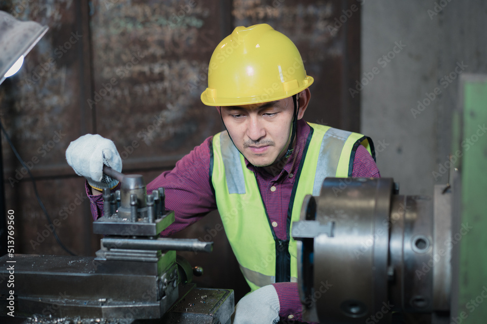 worker metal, Asian mechanical engineer operating industrial lathe ...