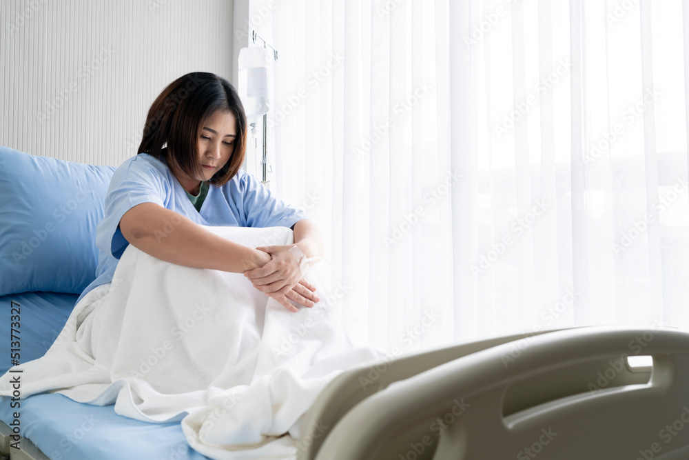 An Asian female patient was hospitalized alone in a bed by the window ...