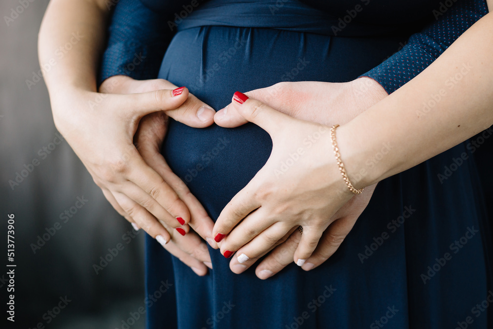 Future parents keep their hands on the stomach of a young pregnant ...