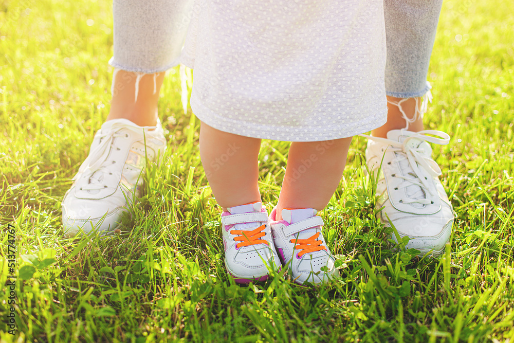 baby`s first steps. mother`s and infant`s feet closeup picture. Stock ...
