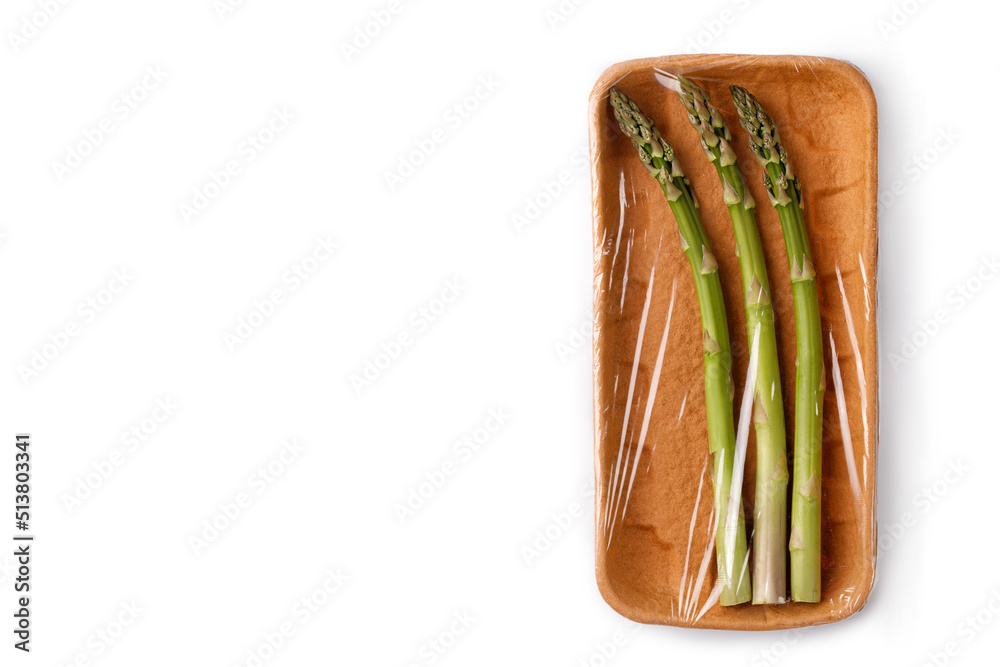 Fresh green asparagus in package isolated on white background. Top view, copy space. Set, group ...