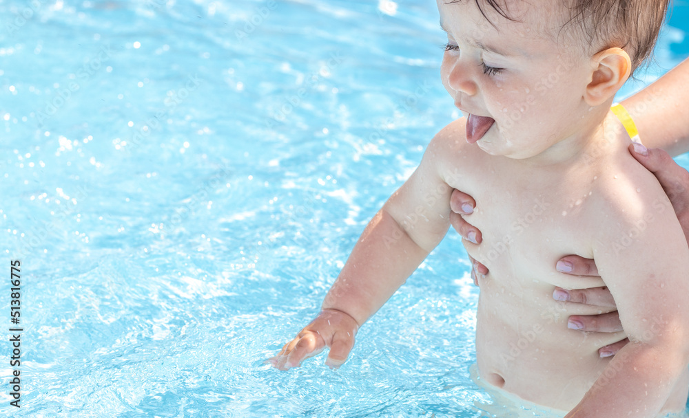 baby boy playing in water pool for kids.cute hands hit the water ...