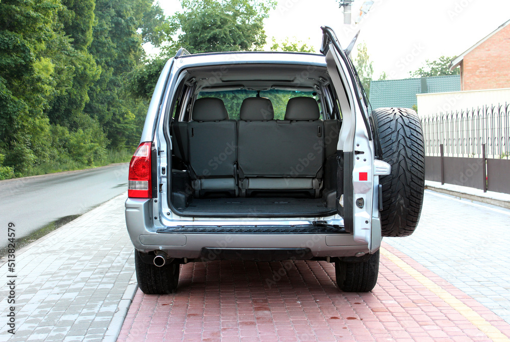 Open back door modern SUV. Clean, open empty trunk in the grey car ...