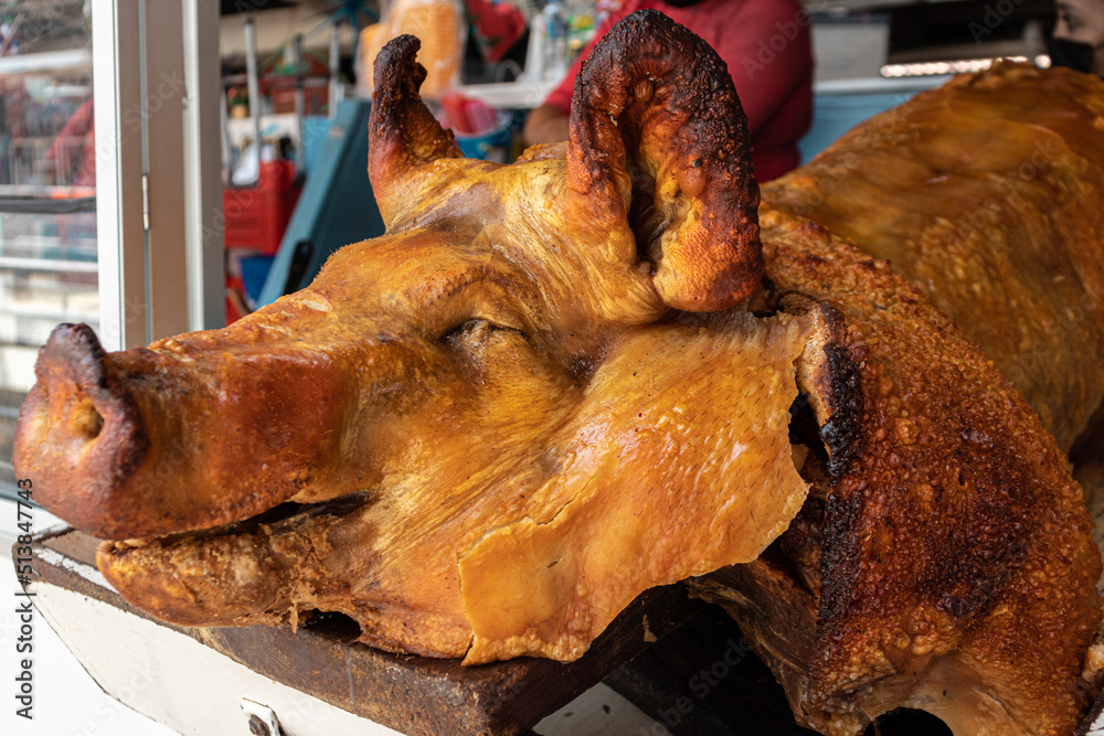 Big whole roasted pig is ready to eat at the food market in Cuenca ...