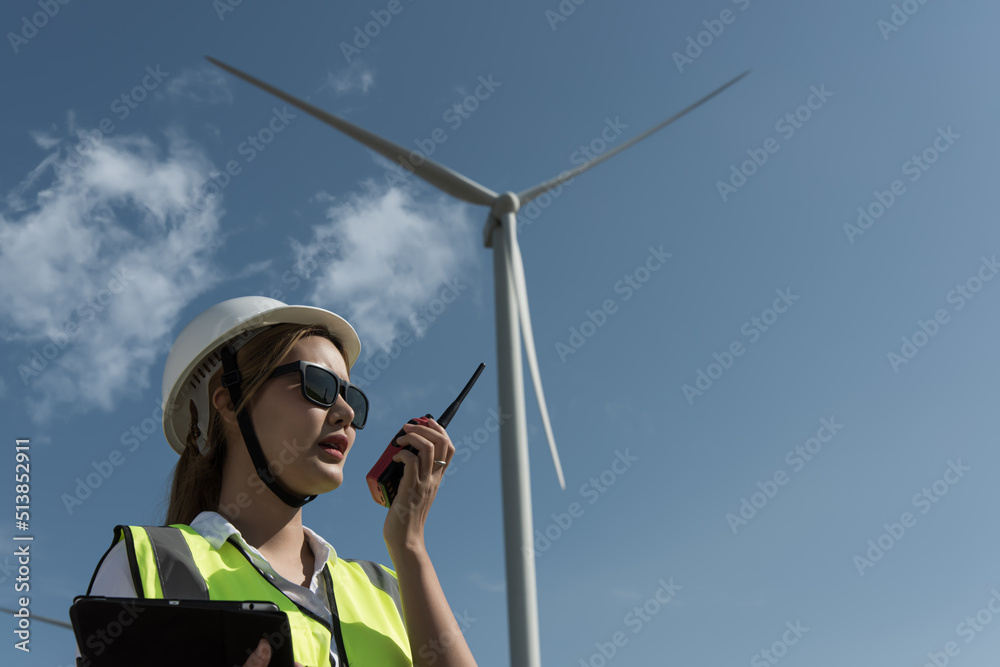person with wind turbine in the field. engineer with turbine in the ...
