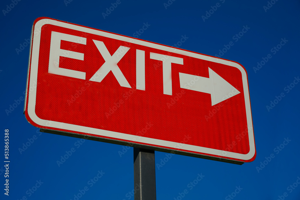 Exit sign against blue sky background. Exit direction. red traffic sign ...