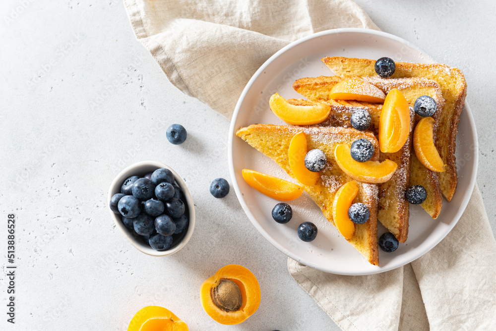 Traditional french toasts with cinnamon, blueberries and apricots ...