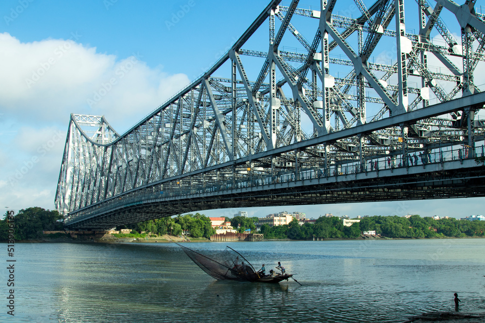 iconic Howrah bridge or Rabindra Setu of Kolkata and boat in river ...