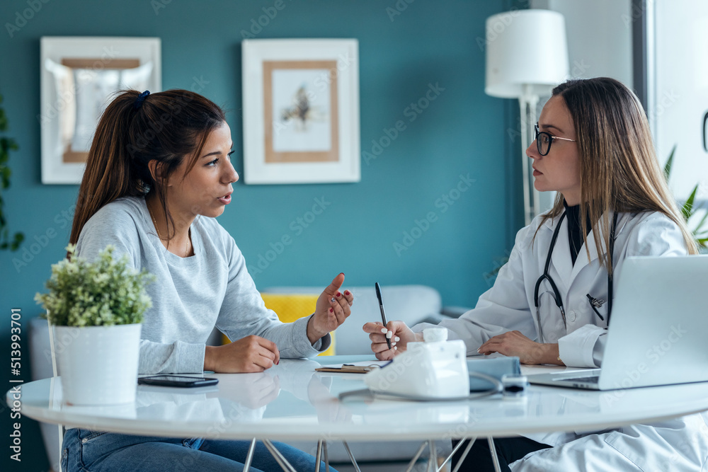 Beautiful female doctor talking while explaining medical treatment to ...