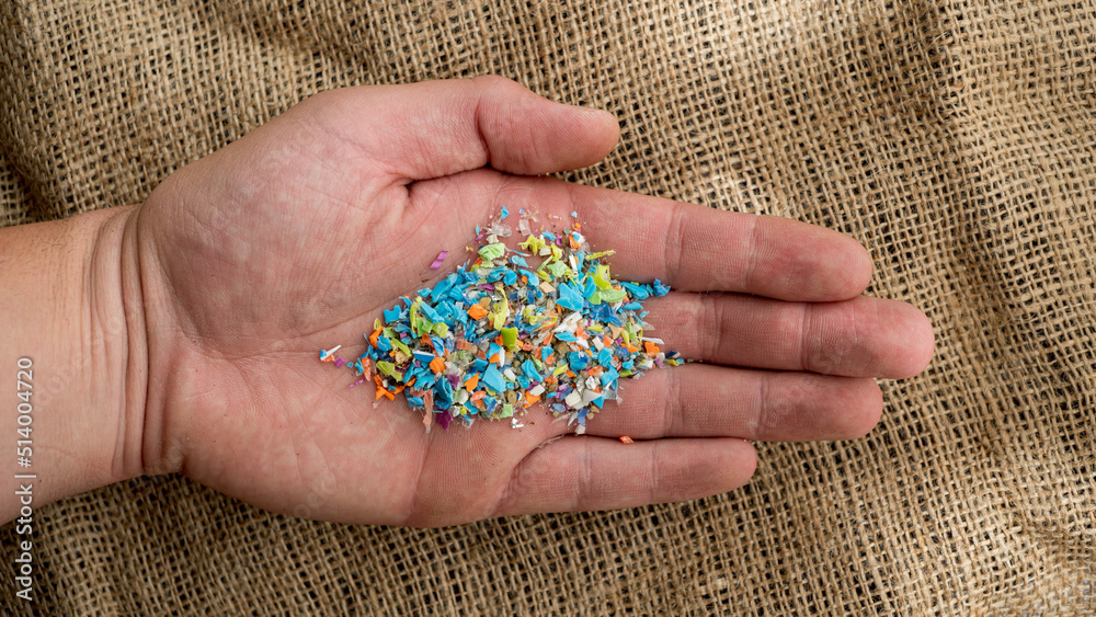 Close-up on micro plastic particles in a person hand. The concept for ...