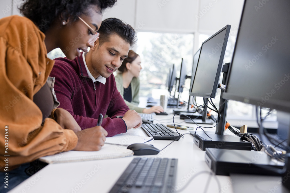 College students researching at computers in library Stock Photo ...