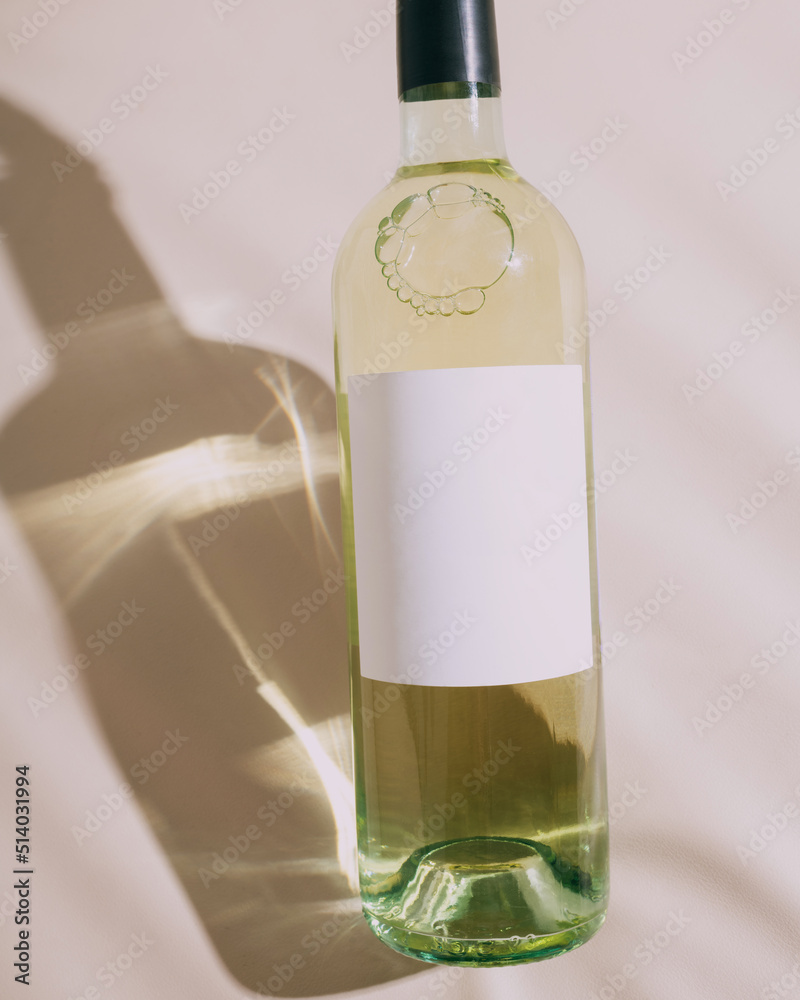 Сlose-up of a bottle of white wine with a beautiful glare from the sun ...