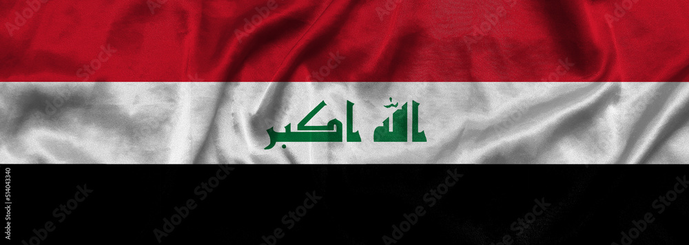 Elongated national flag of Iraq with a fabric texture fluttering in the ...