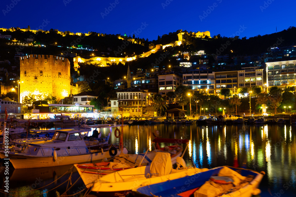 Scenic night view of Alanya cityscape from harbor jetty overlooking ...