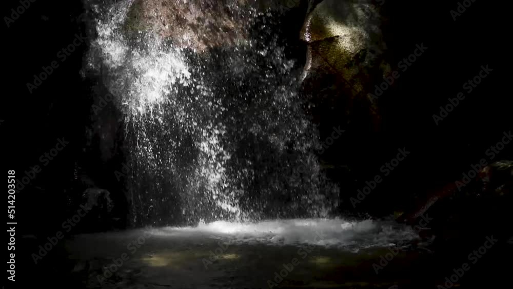 Water falling into a waterfall basin in the dark background 2 Stock ...
