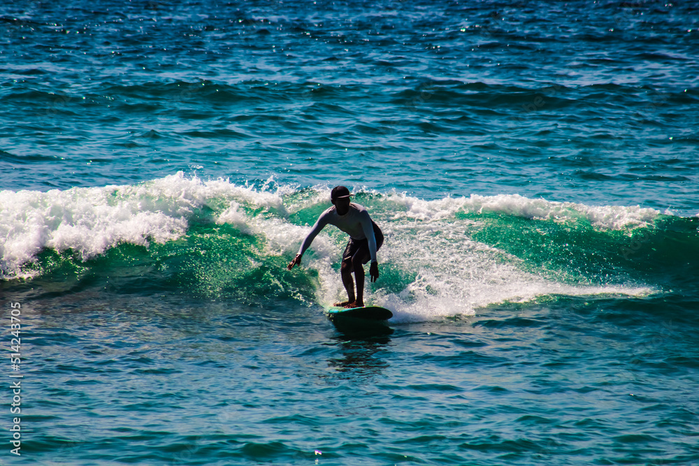 amazing surfer riding the waves silhouette in carrizalillo beach puerto ...