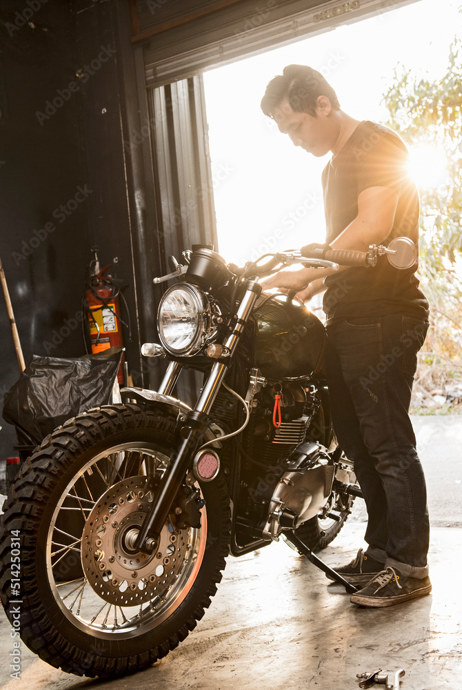 mechanic working on motorcycle at custom bike shop in Bangkok Stock ...