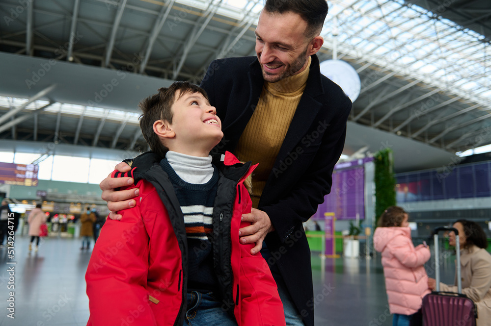 Happy single parent, young father with his son in a departure hall of ...