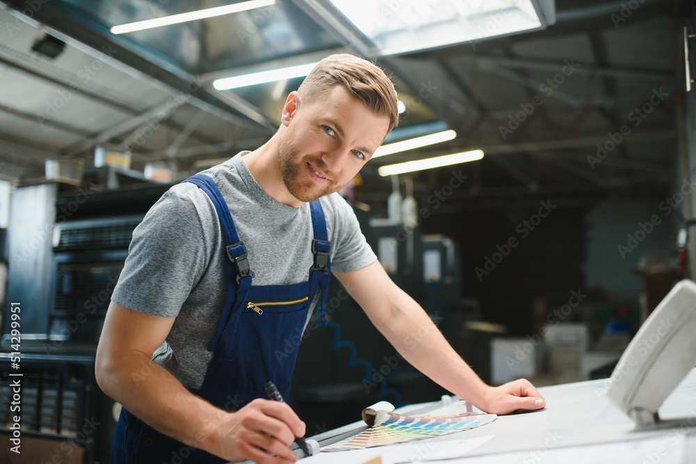 Man worker measuring printing color with spectrometer on the operating ...