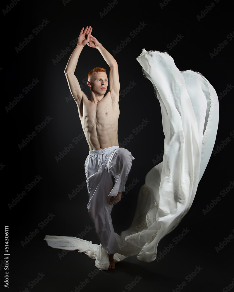 red-haired male dancer demonstrates the choreographic elements of the ...