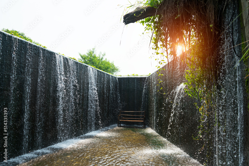 Flowing water like a small waterfall curtain. Water overflowing the ...