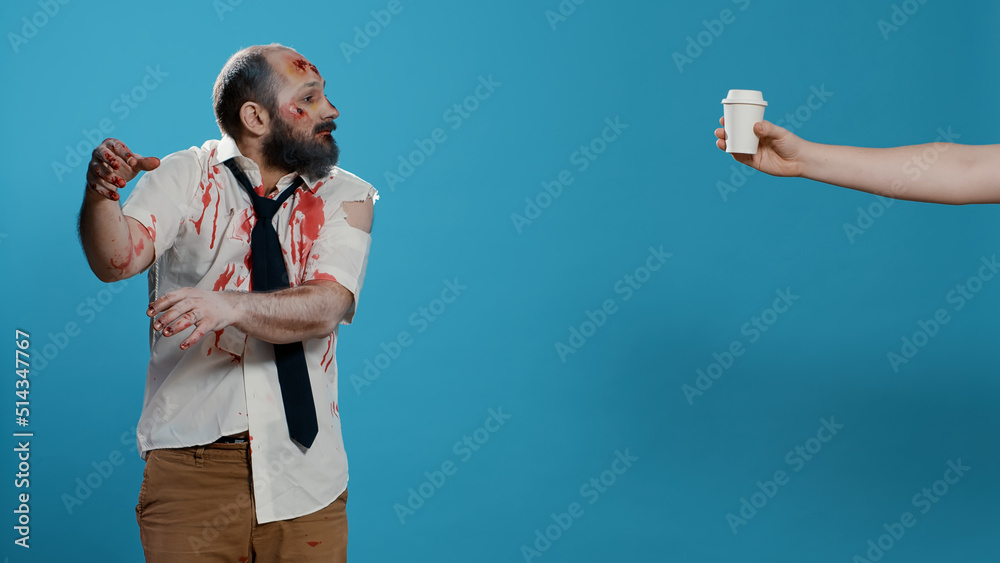Mindless brain-eating zombie trying to get cup of coffee on blue ...