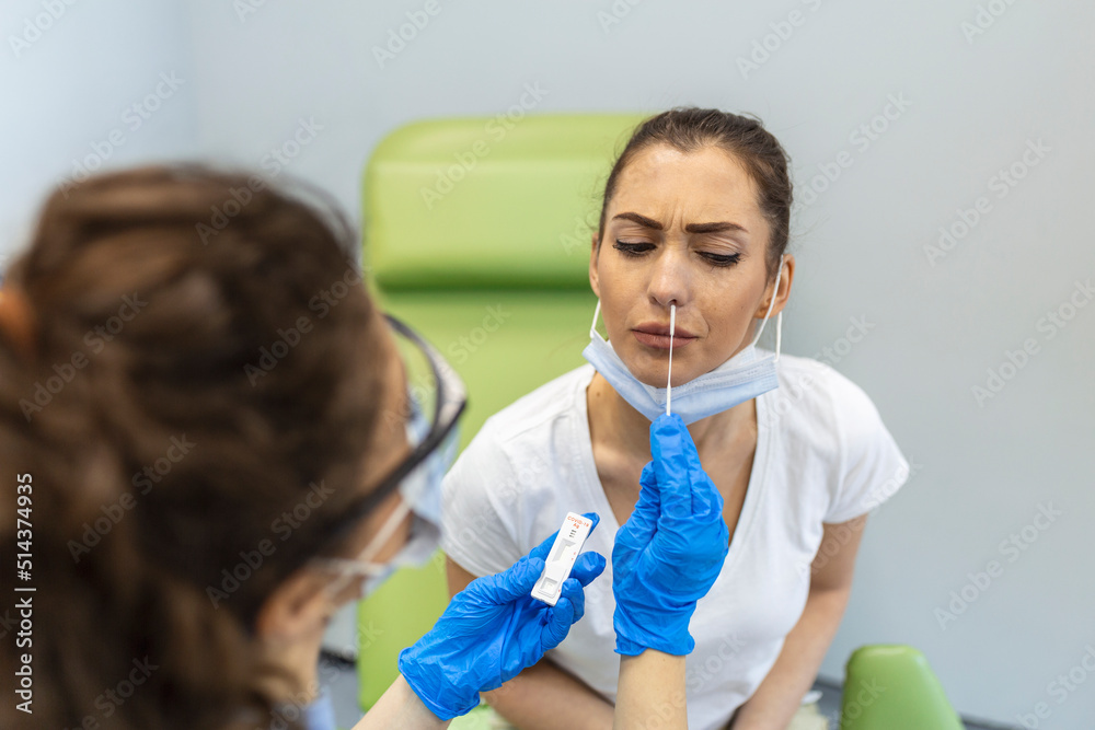 Female patient being tested for Covid-19 with a nasal swab, by a health ...