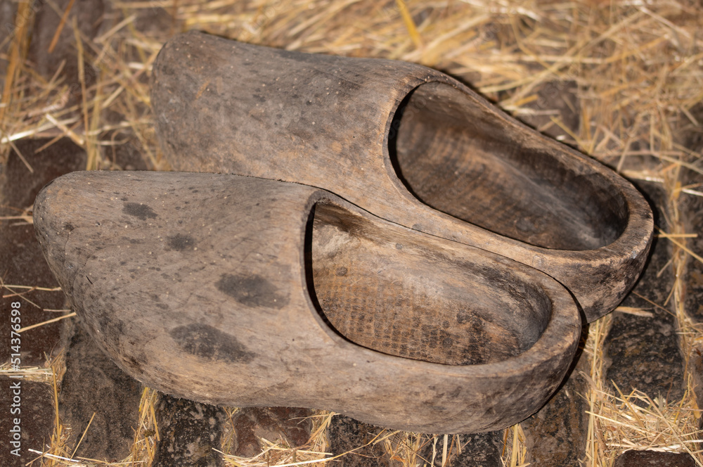 Enkhuizen, Netherlands. June 2022. Old worn clogs against a background ...