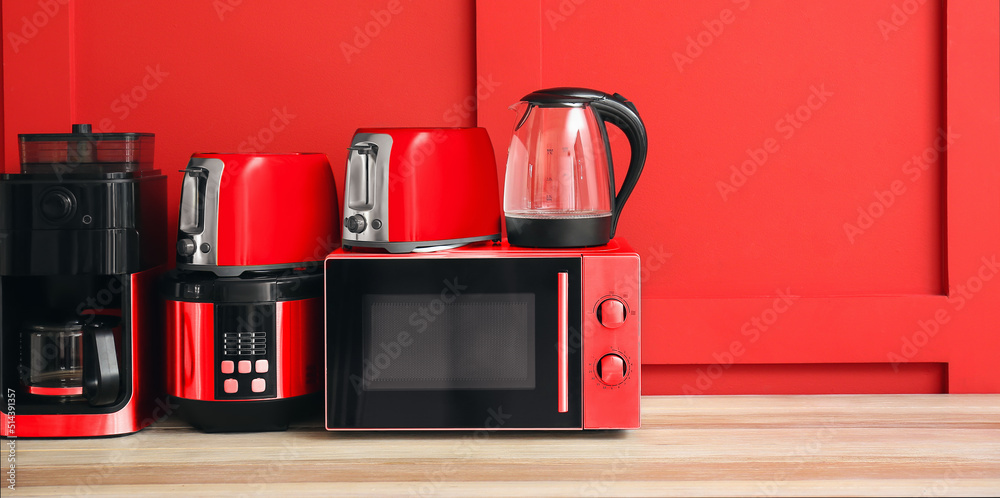 Different household appliances on table in room Stock-Foto | Adobe Stock