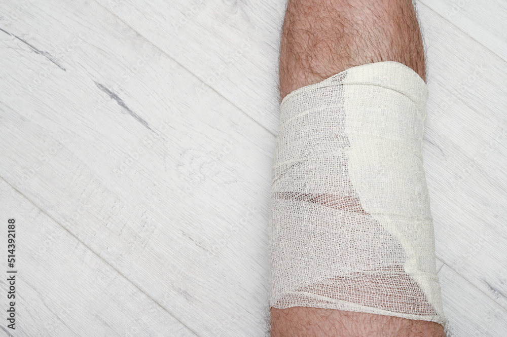 Bandaged leg after knee injury. Elastic self-adhesive bandage. Stock ...