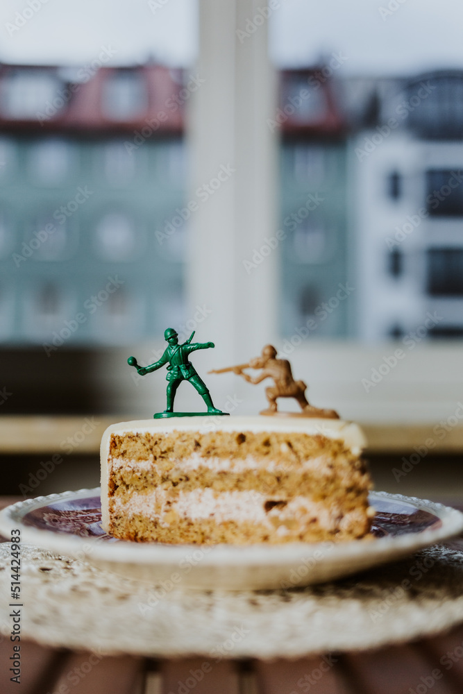 Two Toy Soldiers Fighting On The Top Of Piece Of Cake About Having A ...