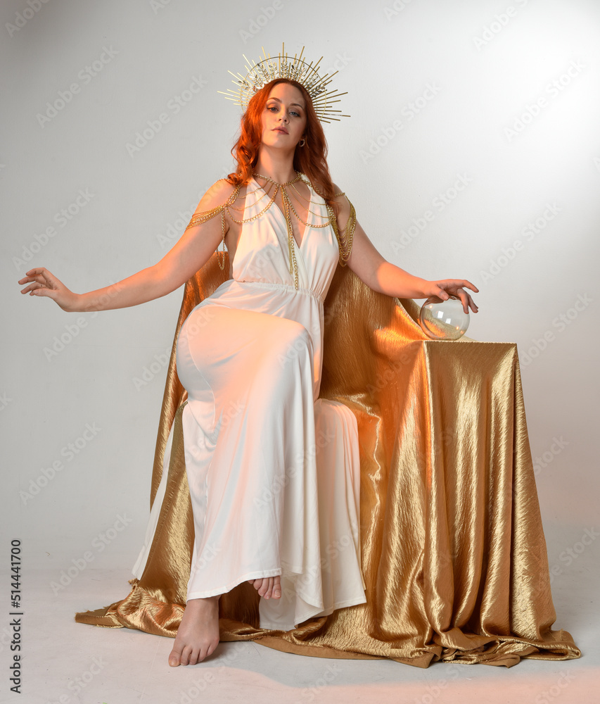 Full length portrait of beautiful red head woman wearing long flowing ...