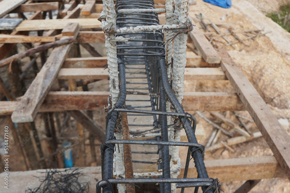 Place the reinforcing steel beams through the steel columns on the ...
