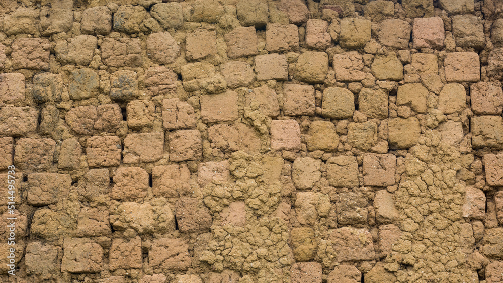 section of a old unbaked brick wall surface, also known as sun dried ...