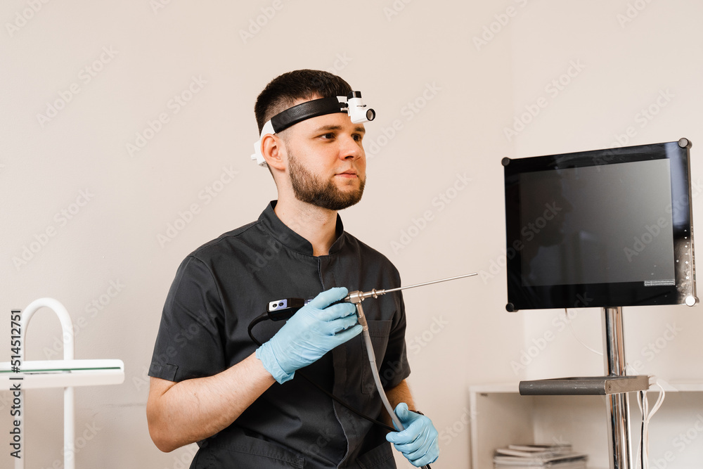 ENT doctor otolaryngologist with endoscope in hands. Prepearing for ...